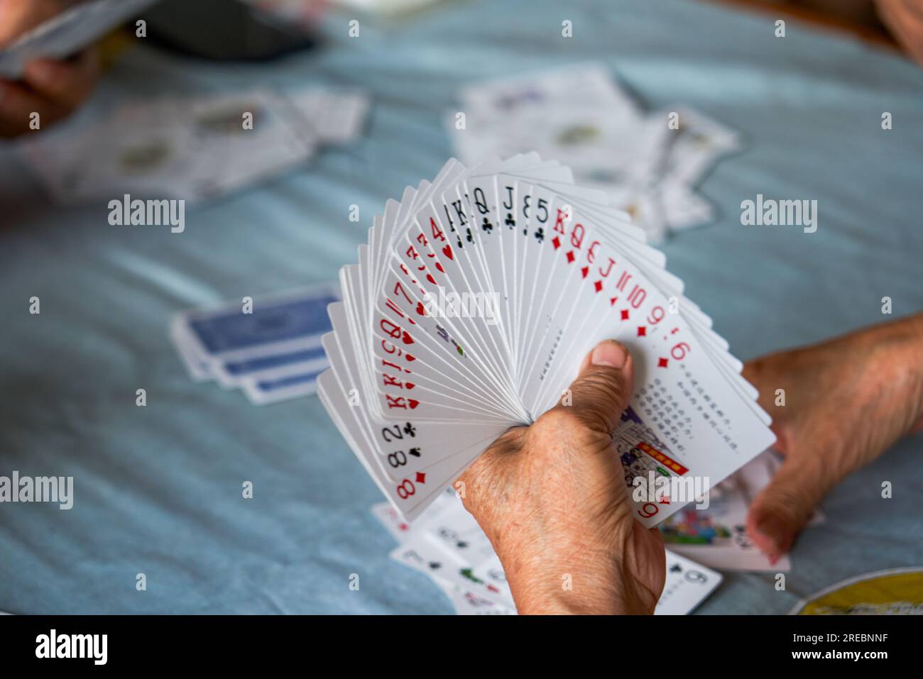A group of old people sit around and play poker card Stock Photo - Alamy