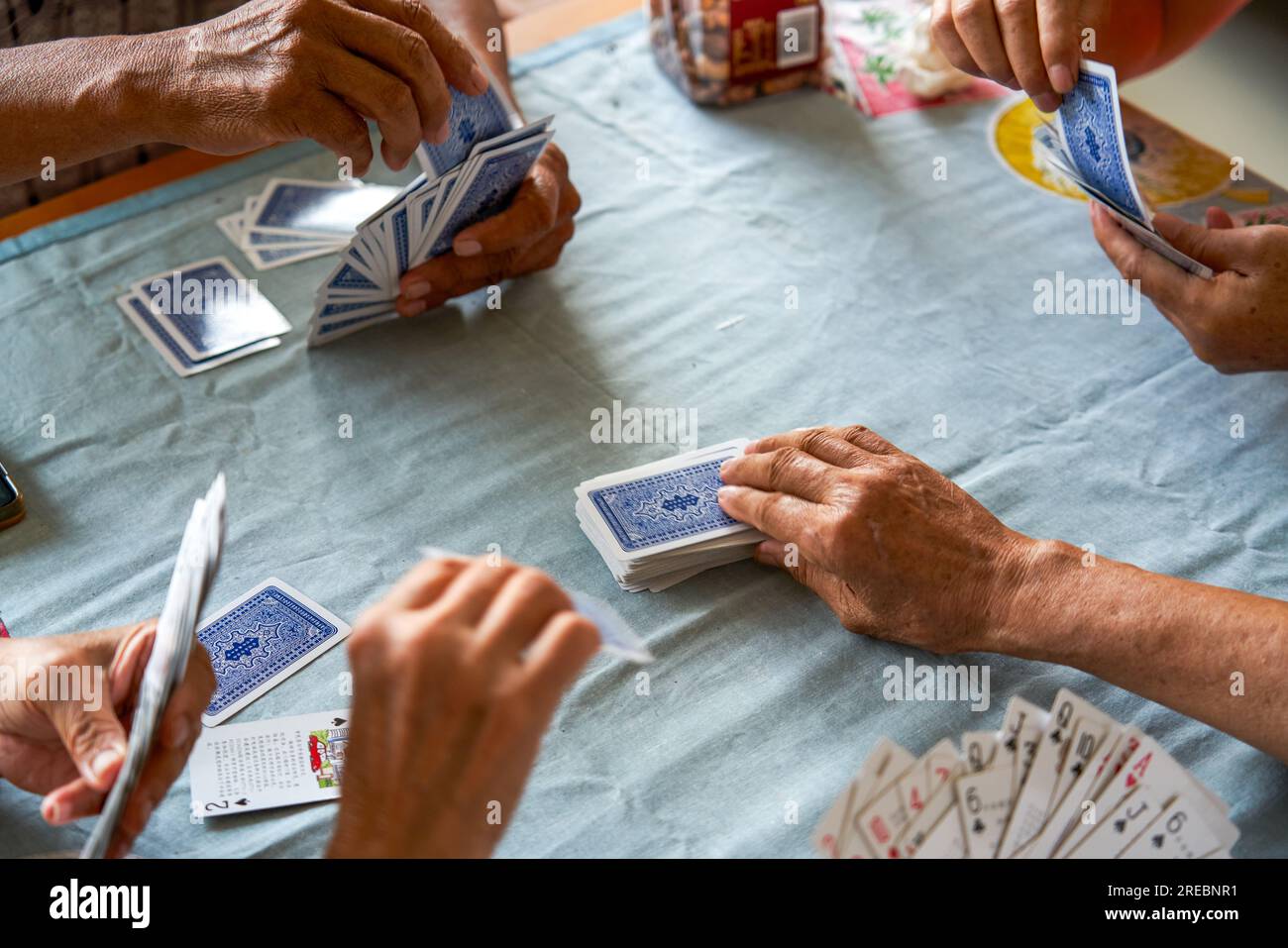 A group of old people sit around and play poker card Stock Photo - Alamy