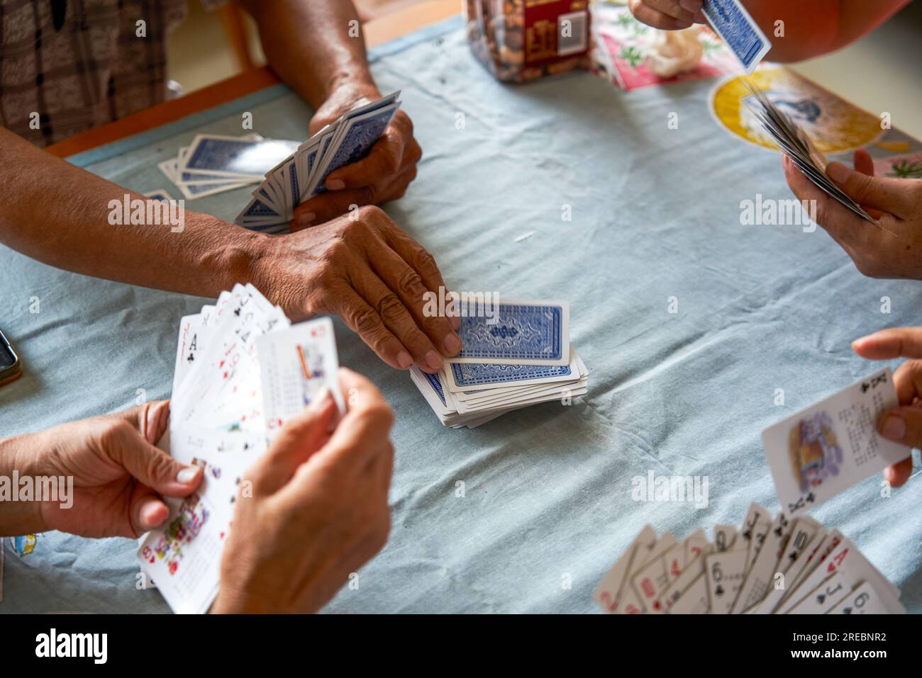 A group of old people sit around and play poker card Stock Photo - Alamy