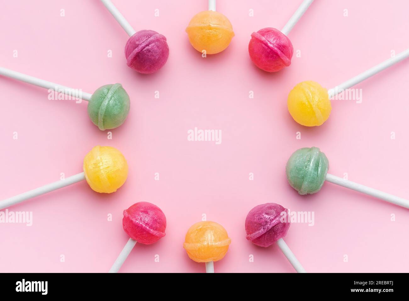 Colorful sweet lollipops over pink background. Flat lay, top view Stock ...