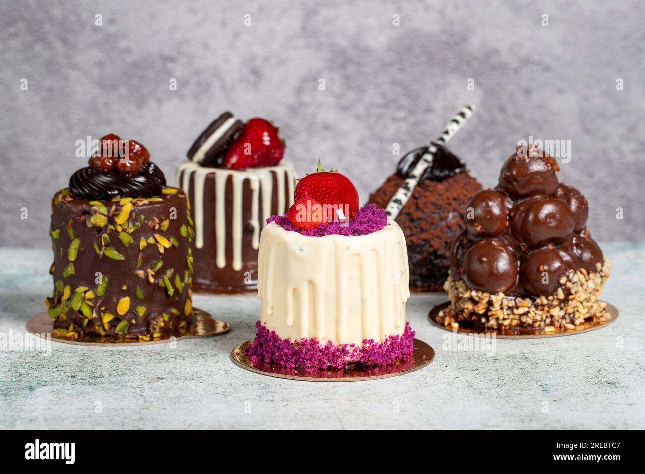 Types of cakes. Assortment of chocolate and fruit cakes on a gray ...