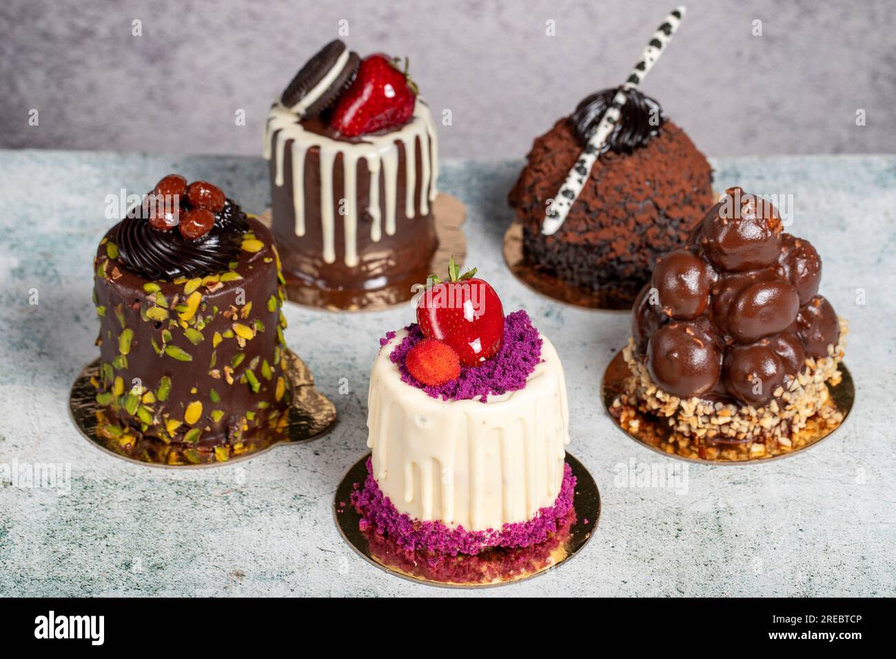 Types of cakes. Assortment of chocolate and fruit cakes on a gray ...