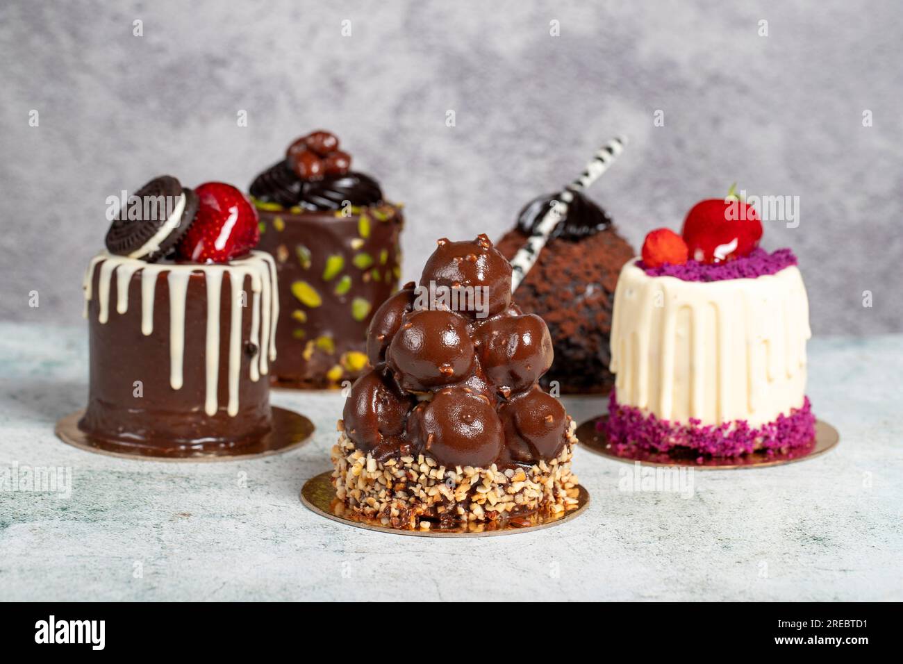 Types of cakes. Assortment of chocolate and fruit cakes on a gray ...