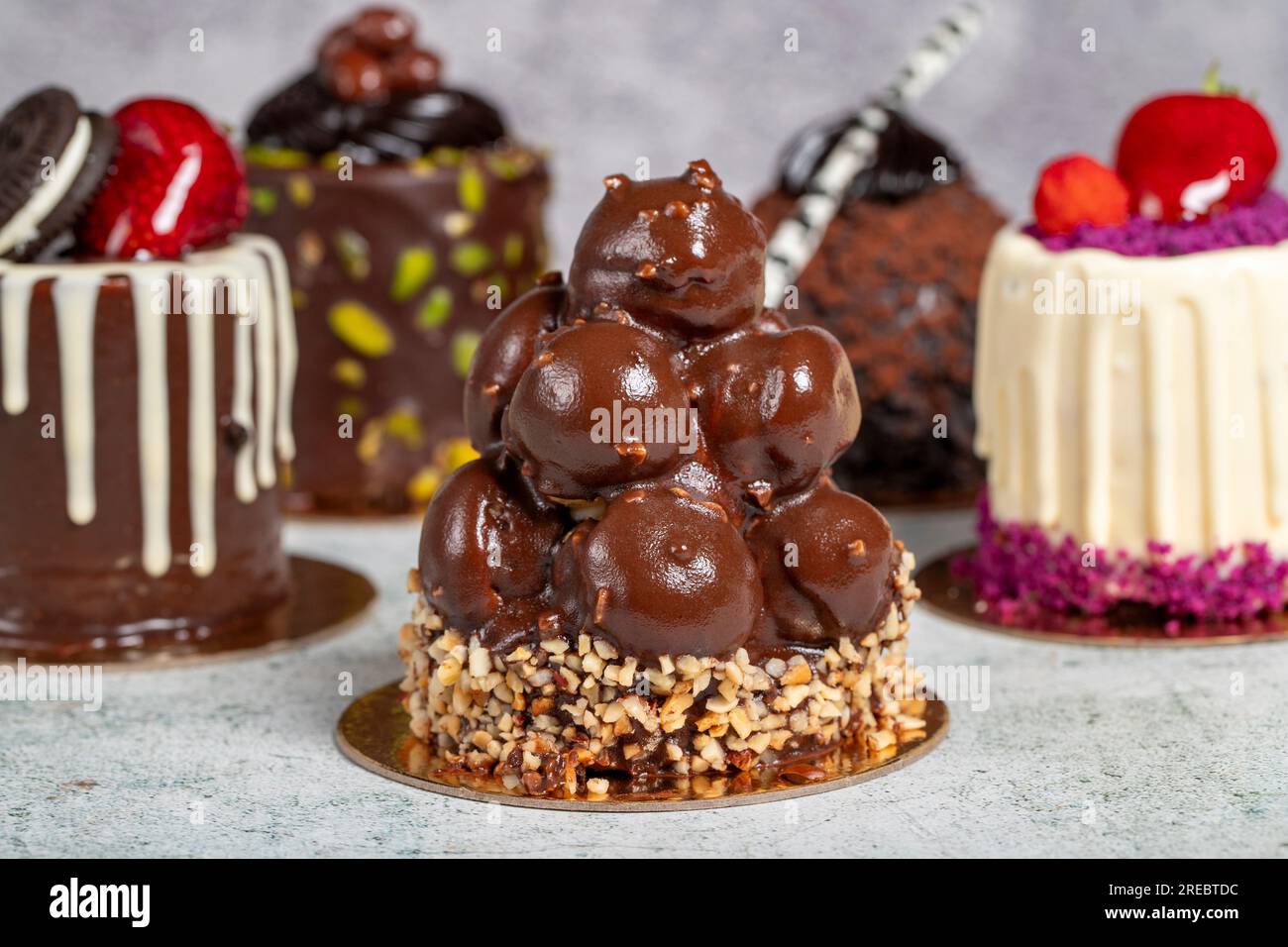 Types of cakes. Assortment of chocolate and fruit cakes on a gray ...
