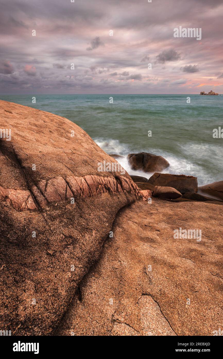 Rocks on beach near green ocean at magnetic island Stock Photo - Alamy
