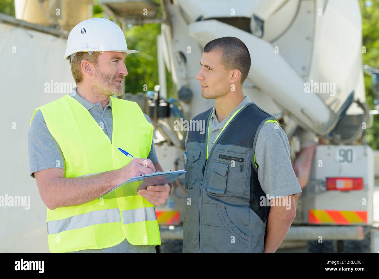 two construction engineers supervising work at building site Stock ...