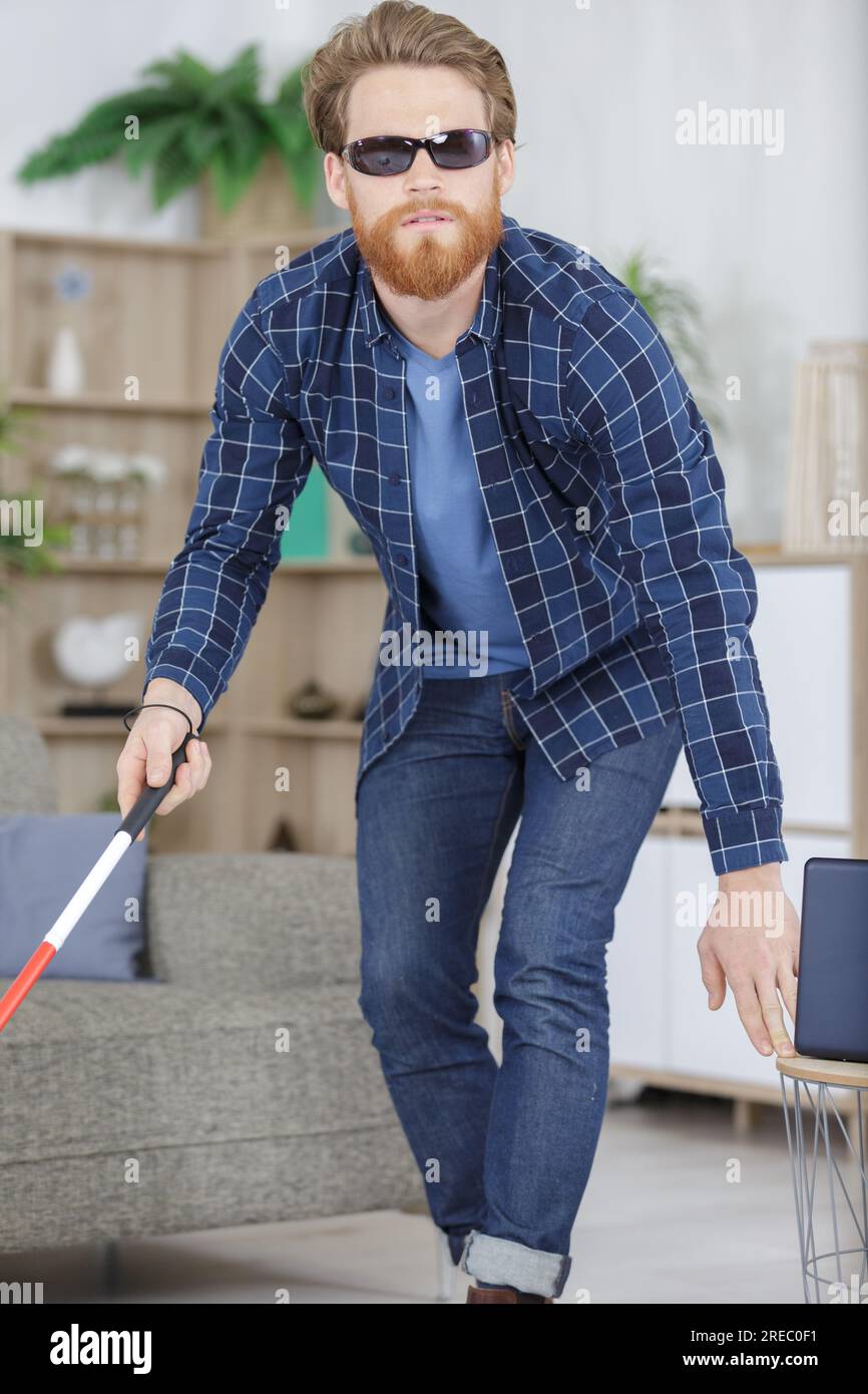 visually impaired man using stick to move around the home Stock Photo ...