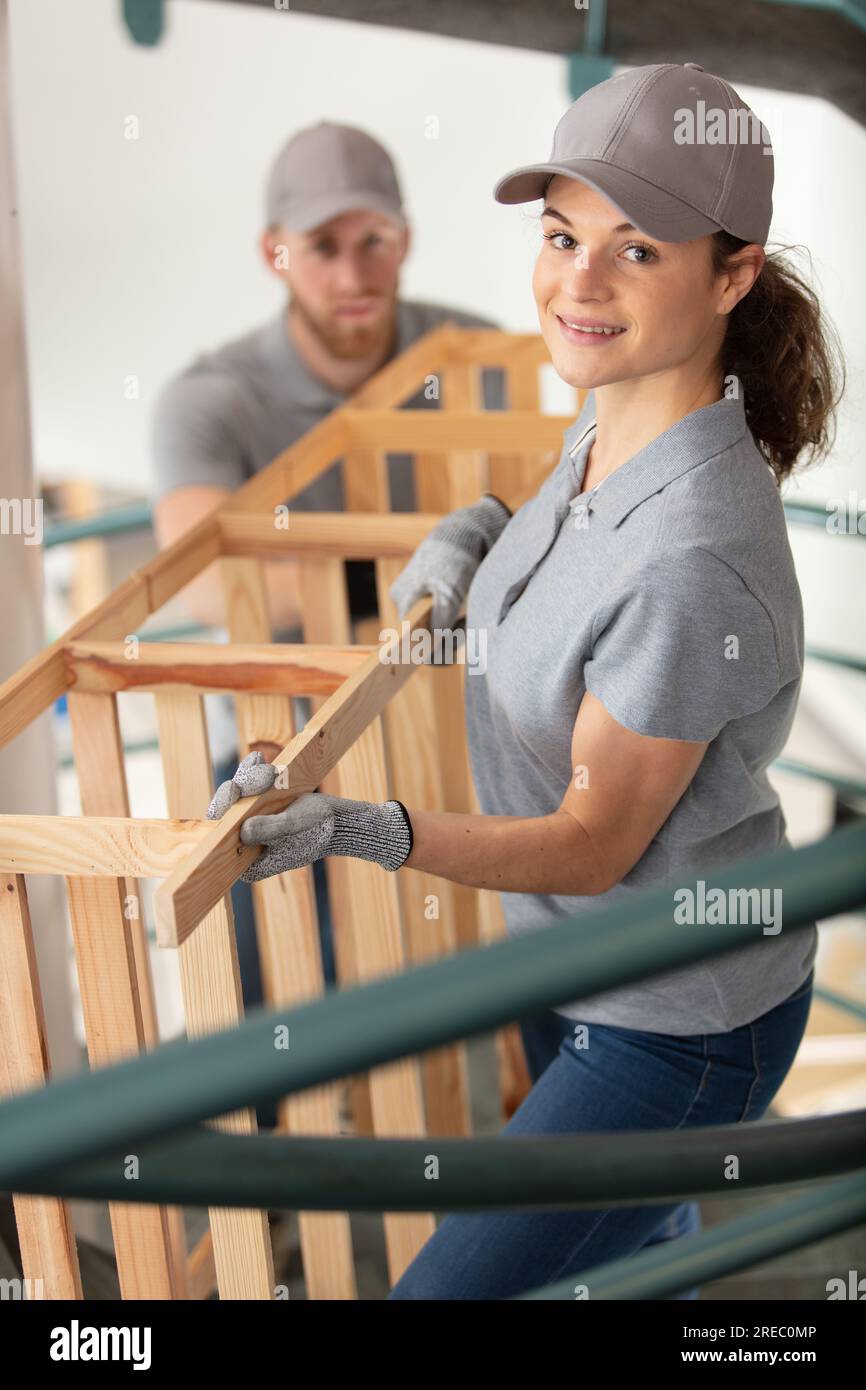 workers in the warehouse carrying a furniture Stock Photo - Alamy