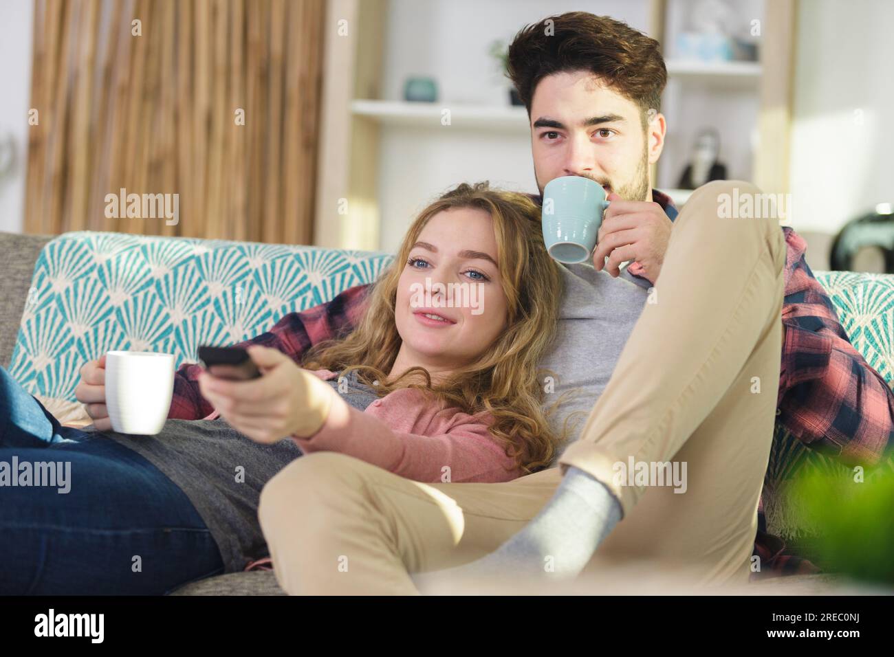 Family sat on sofa hi-res stock photography and images - Alamy