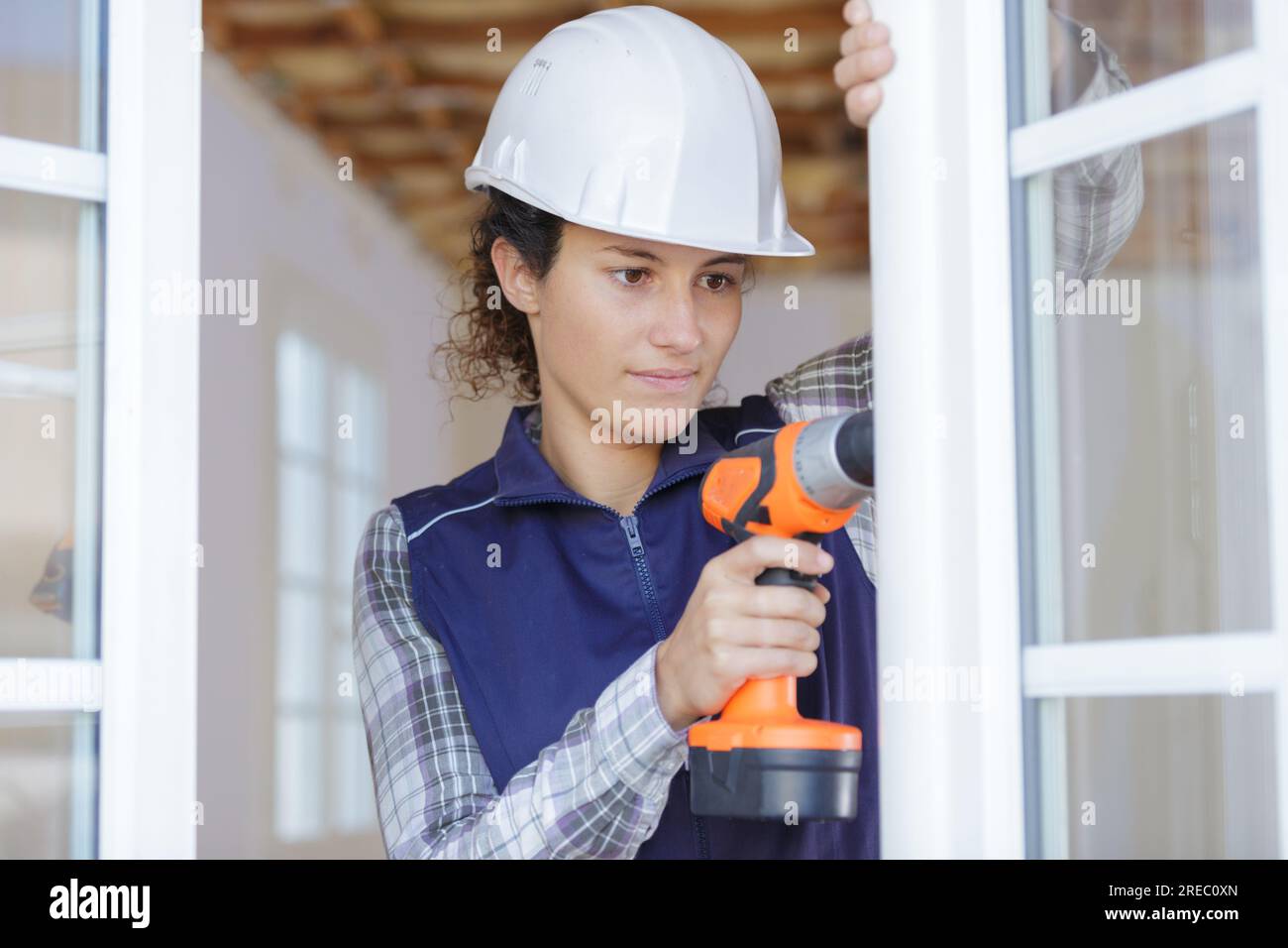 construction worker drilling a window Stock Photo - Alamy