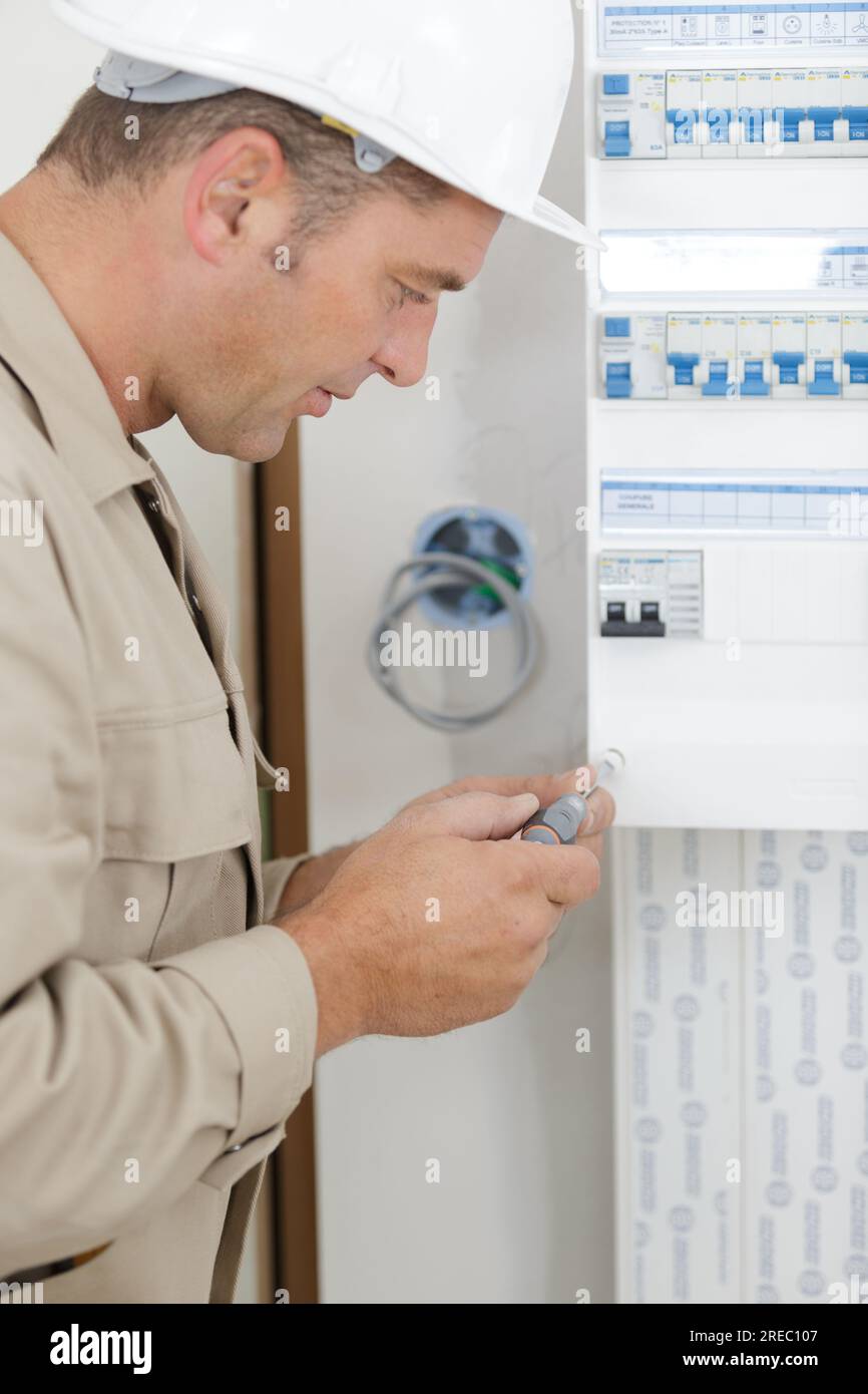 electromechanic working with power electric line Stock Photo - Alamy