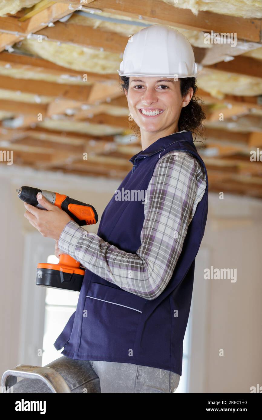 female builder using a drill Stock Photo - Alamy