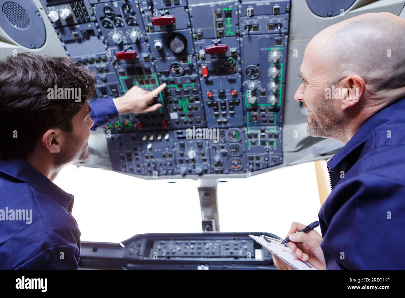 a technician inspecting cockpit panel Stock Photo - Alamy