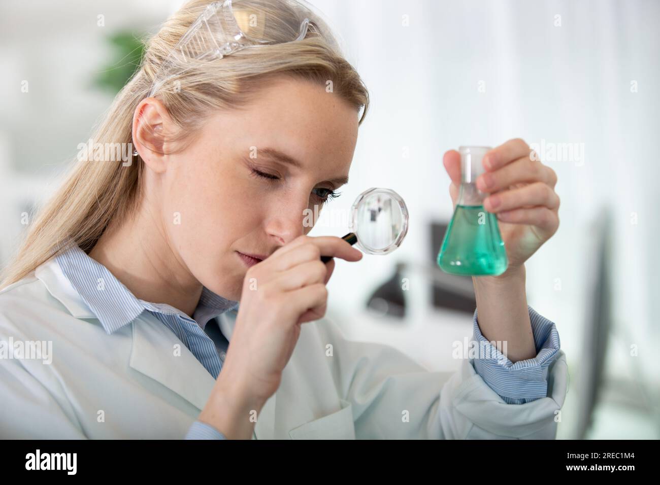 young attractive female scientist in the scientific chemical laboratory ...