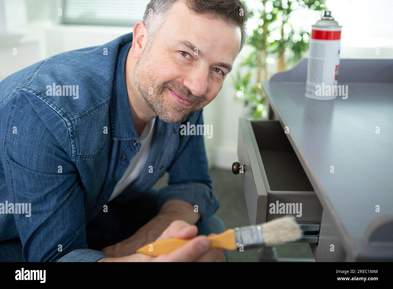 Man paints wooden boards hi-res stock photography and images - Alamy