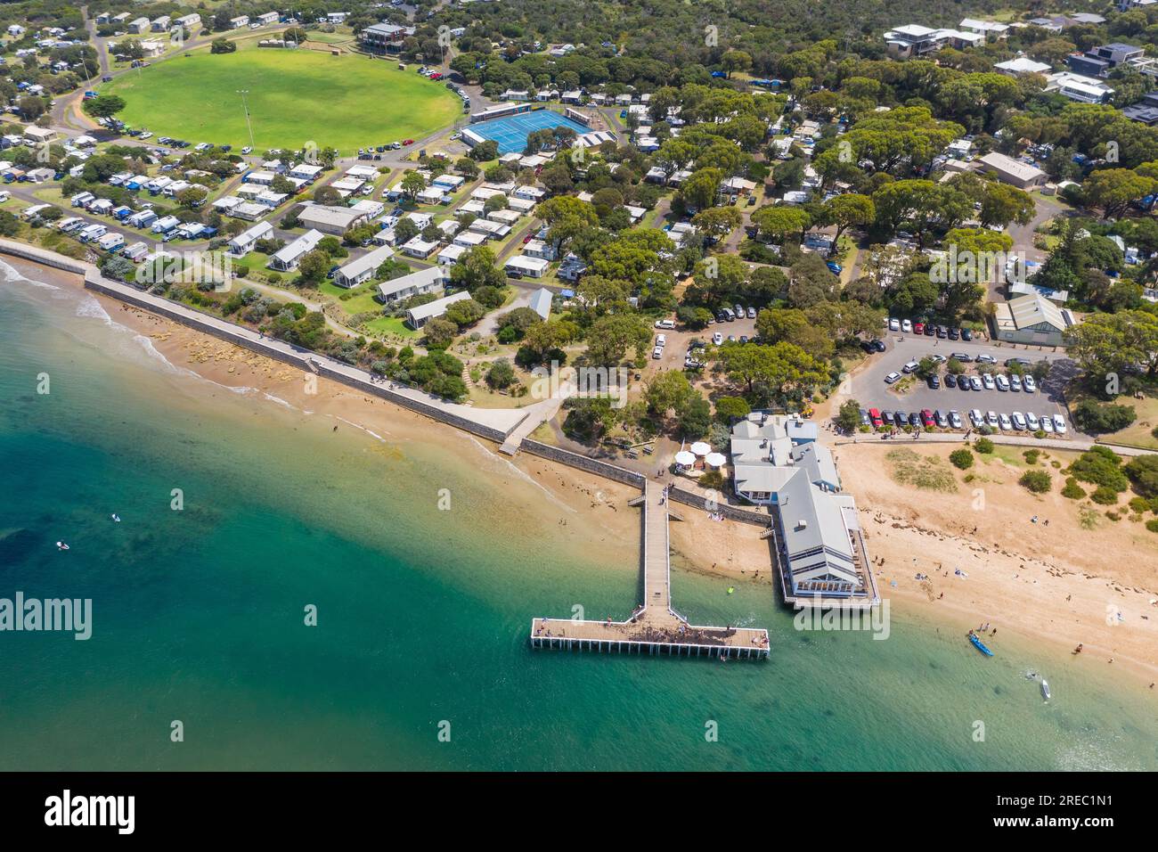 Aerial view of a t shaped jetty crossing a sandy beach to a coastal ...
