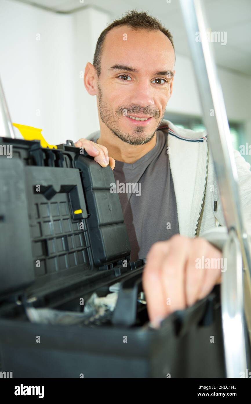 worker taking a tool out of the toolbox Stock Photo - Alamy