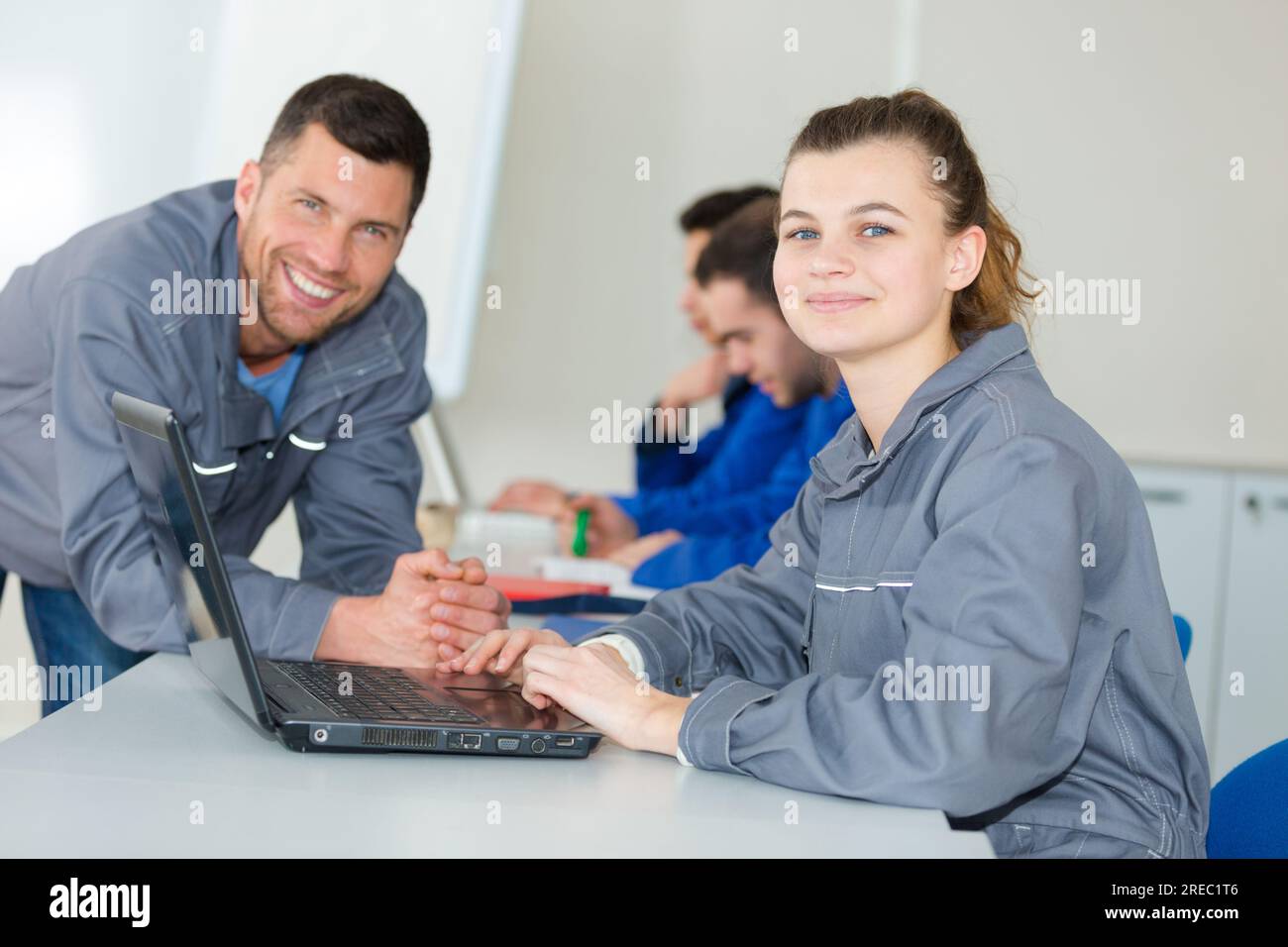 teacher helping female engineer student in class Stock Photo - Alamy