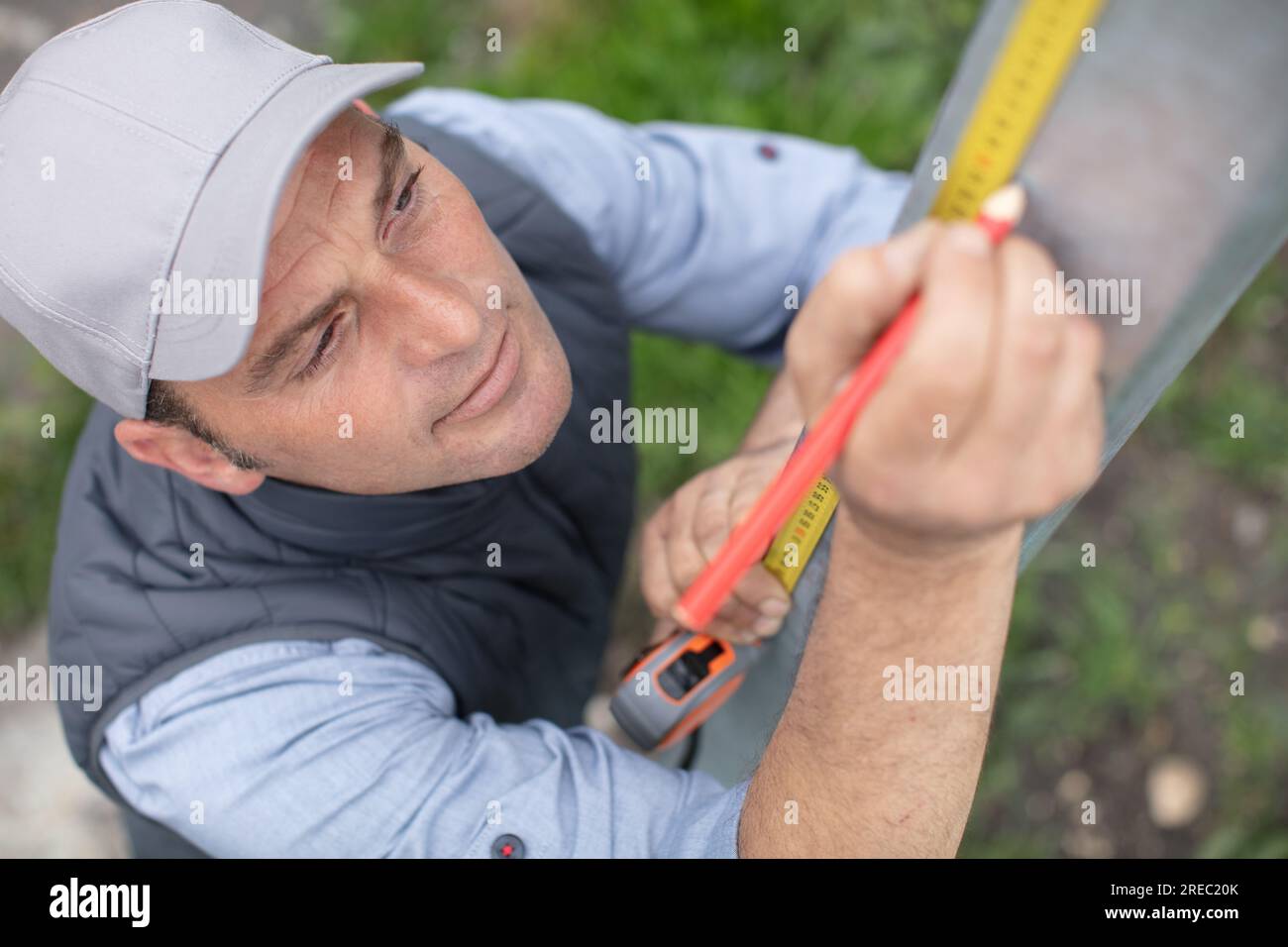 construction worker in protective checking a metal bar Stock Photo - Alamy