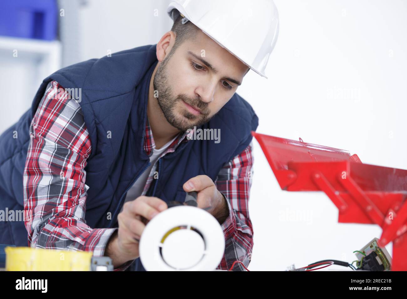 a man screws plastic object Stock Photo - Alamy