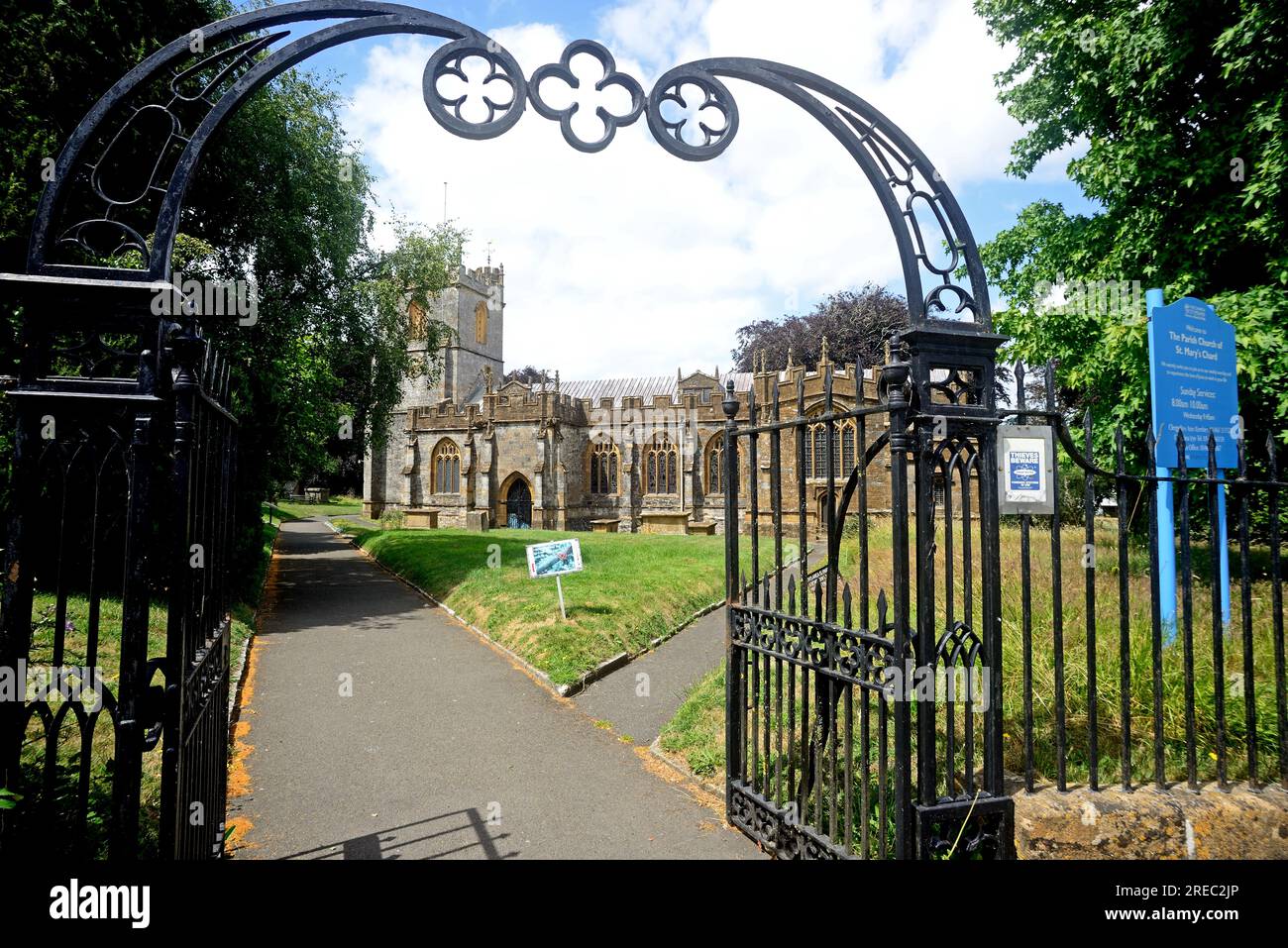 Church of St Mary the Virgin seen through a wrought iron entrance gate ...