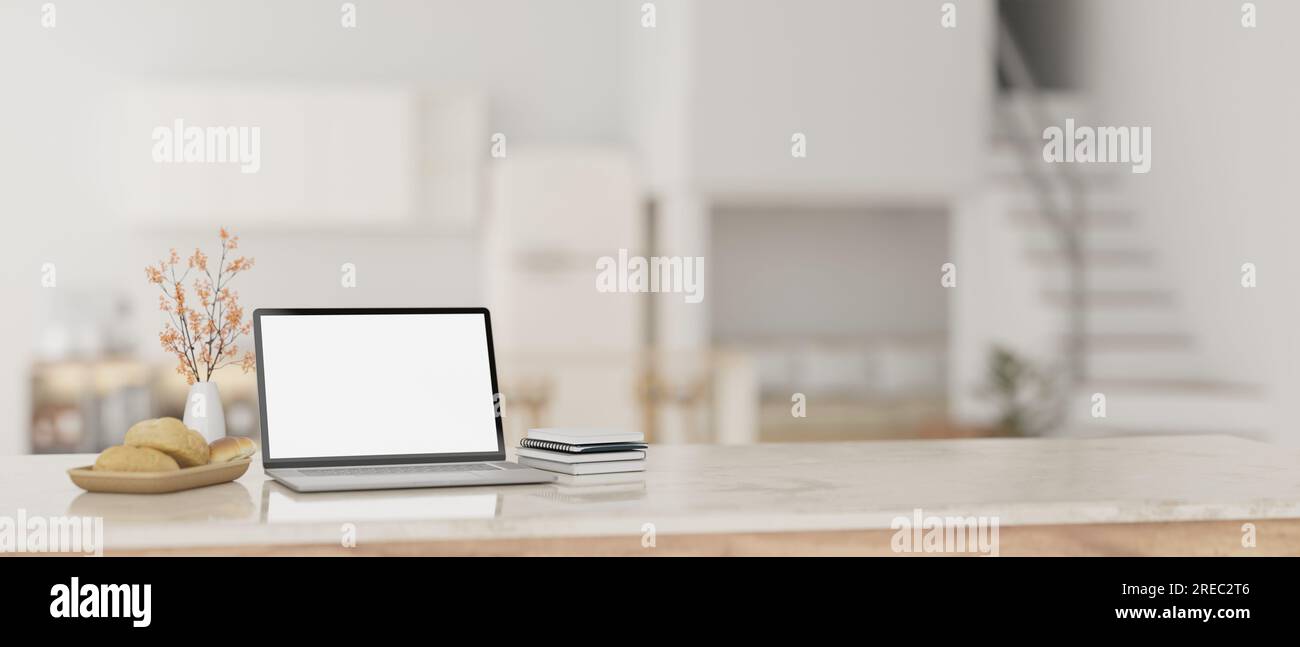 A modern home workspace with a laptop white screen mockup, books, and ...