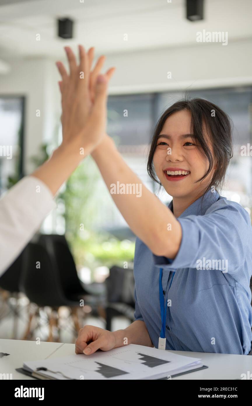 Female co workers celebrating high five hi-res stock photography and ...