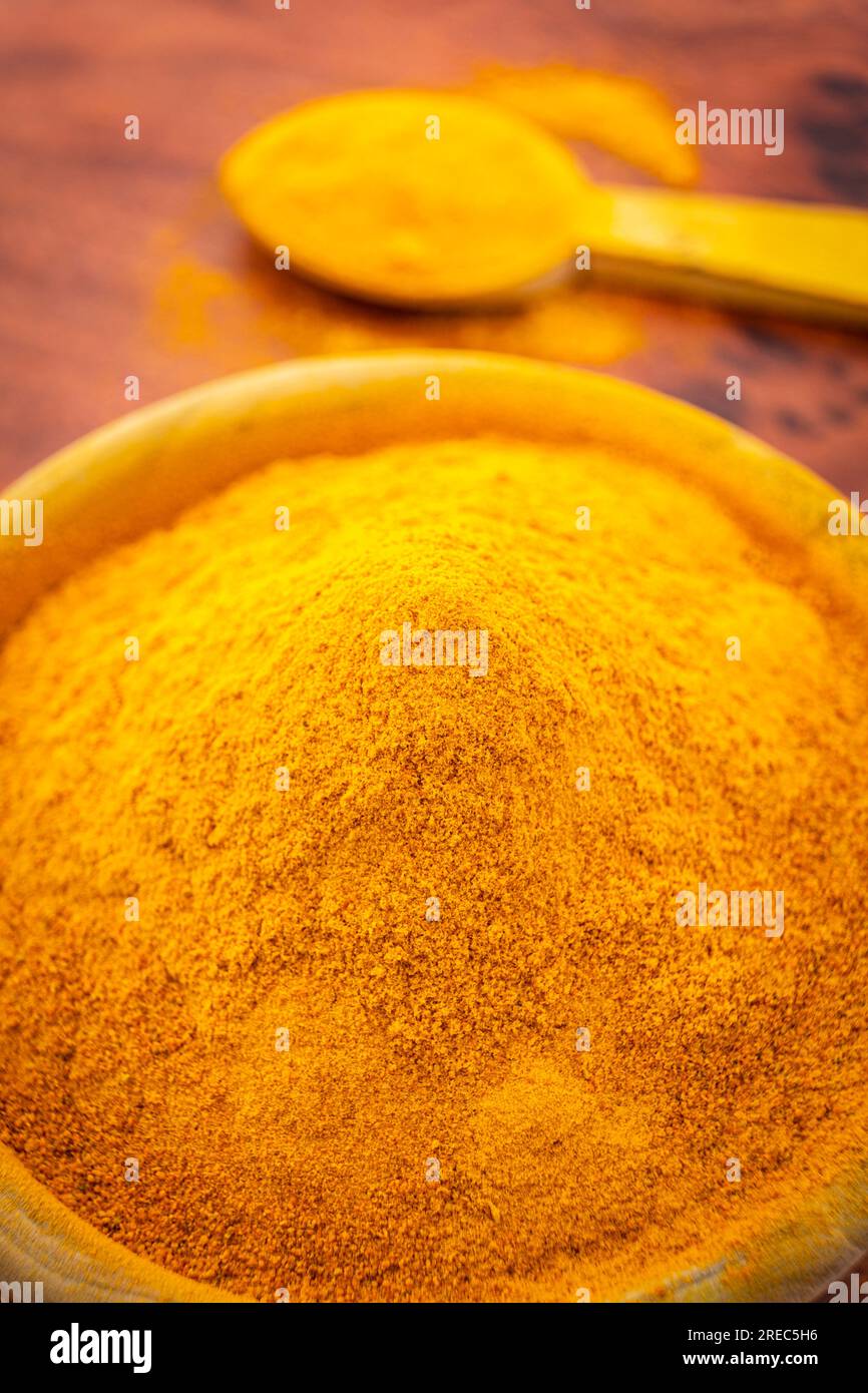 ground turmeric on a wood Stock Photo - Alamy