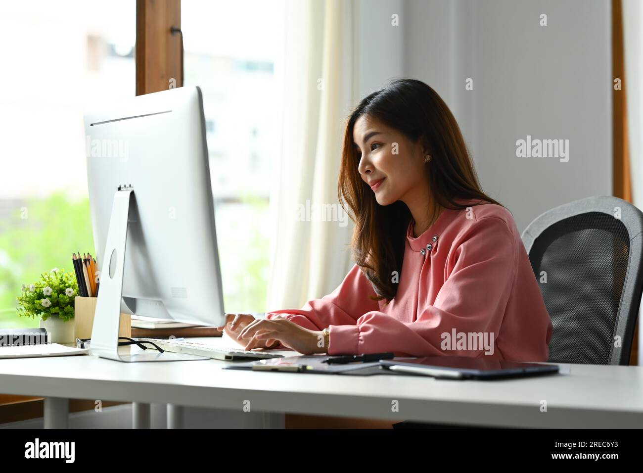 Beautiful woman entrepreneur watching online webinar on computer screen ...