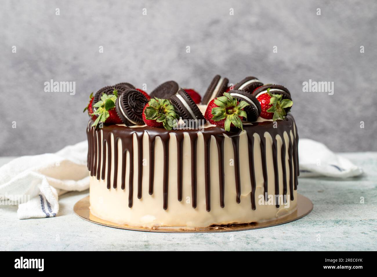 Chocolate cake. Liquid chocolate and strawberry birthday cake on gray ...