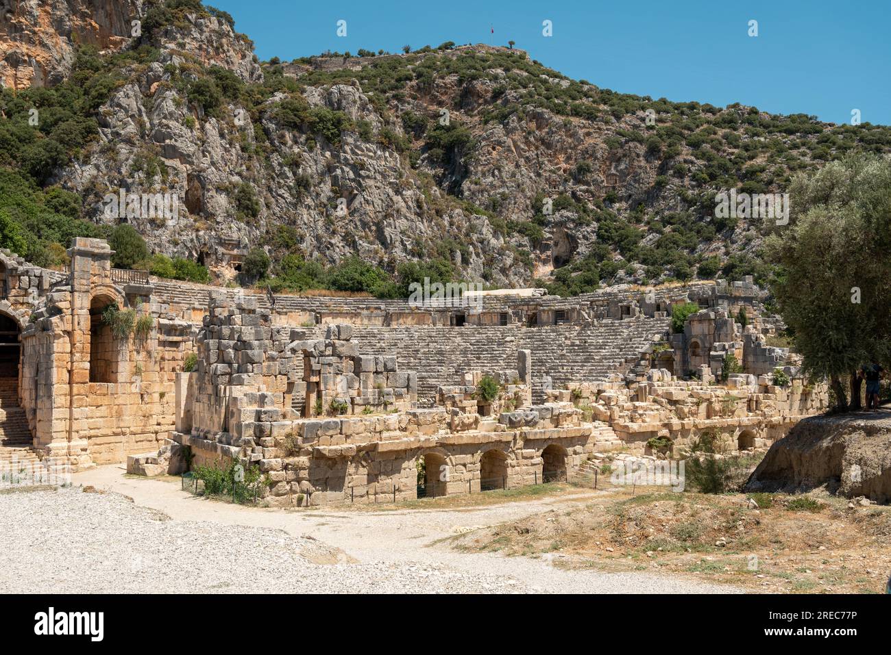 The ruins of the amphitheater and ancient rock tombs in the ancient city of Myra in Demre ...