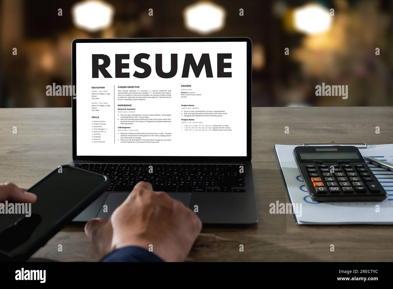 Businessmen Reading Resumes for a new job use laptops and CVs in the ...