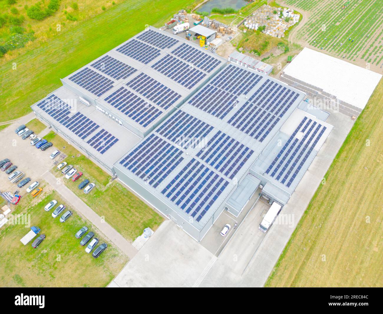 Aerial view of modern storage warehouse with solar panels on the roof ...