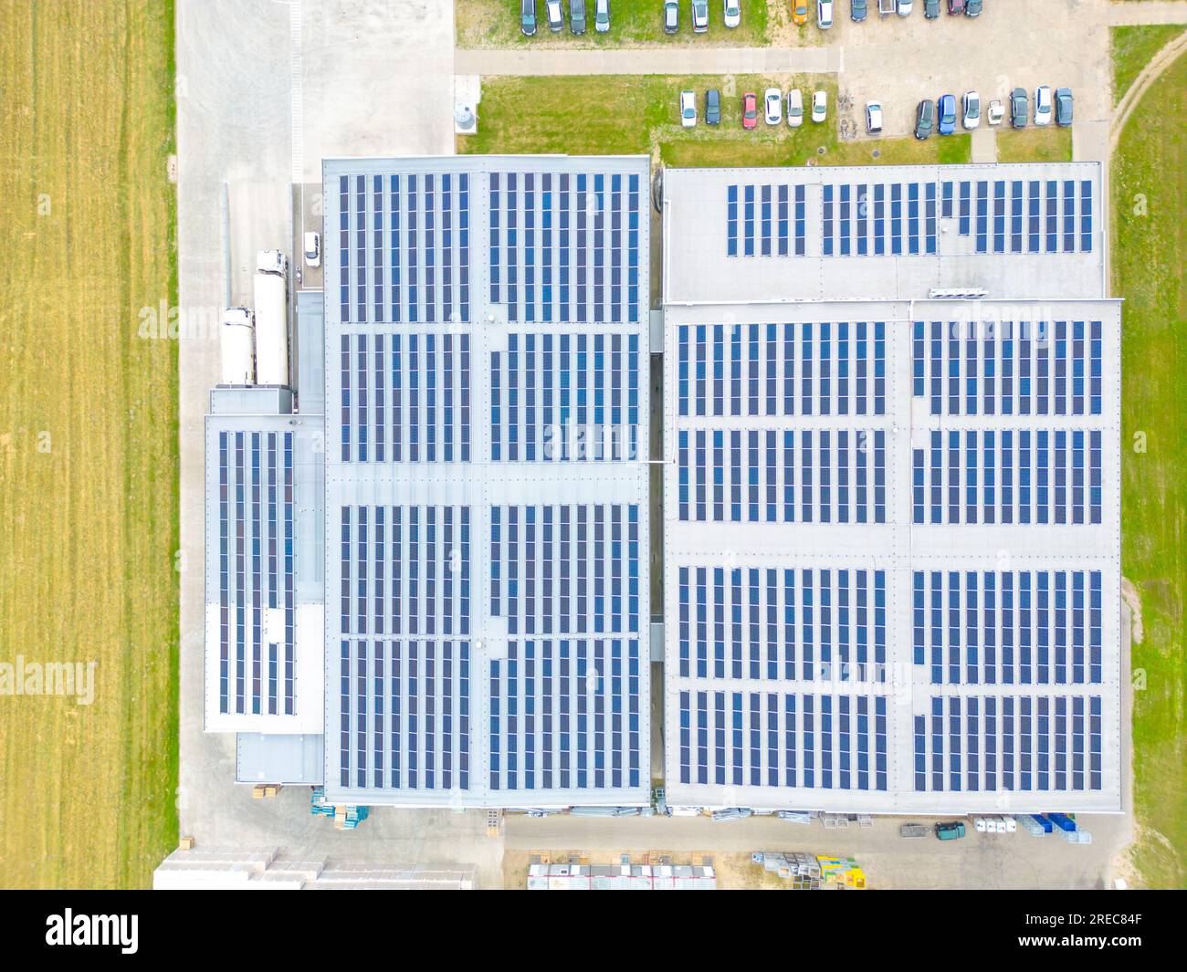 Aerial view of modern storage warehouse with solar panels on the roof ...