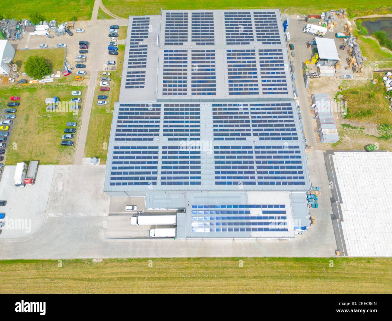 Aerial view of modern storage warehouse with solar panels on the roof ...