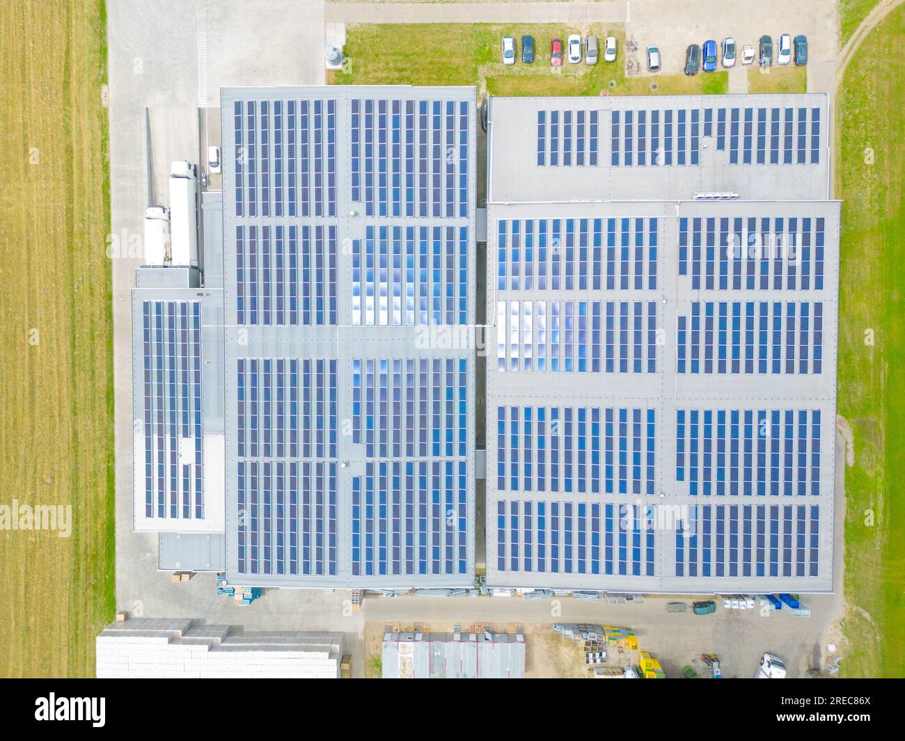 Aerial view of modern storage warehouse with solar panels on the roof ...