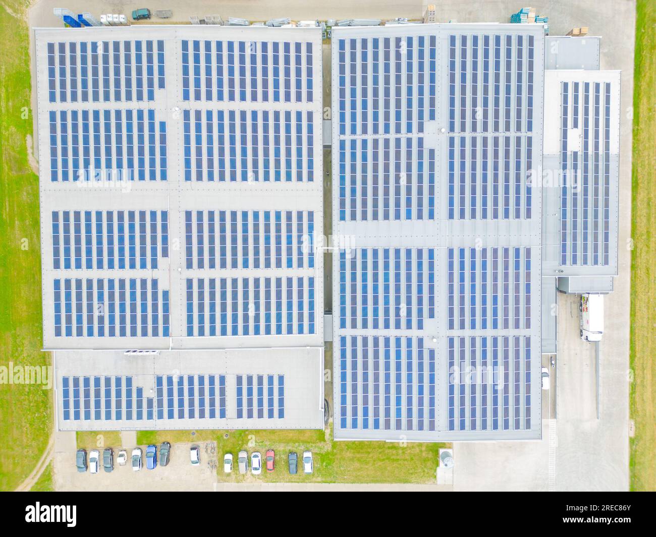 Aerial view of modern storage warehouse with solar panels on the roof ...