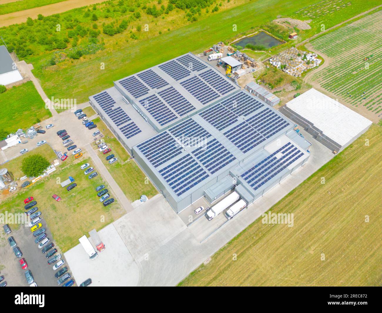 Aerial view of modern storage warehouse with solar panels on the roof ...