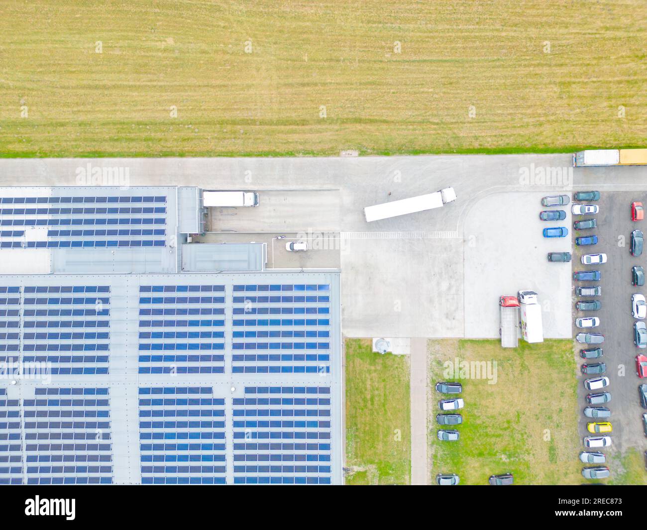 Aerial view of modern storage warehouse with solar panels on the roof ...