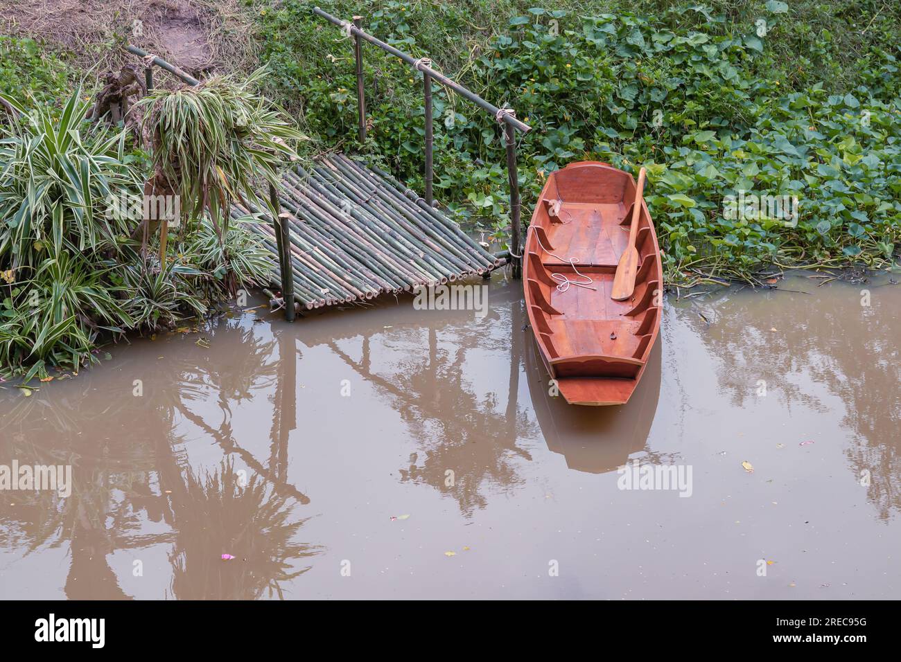 Wooden boat moored at the bamboo pier along the swamp Stock Photo - Alamy