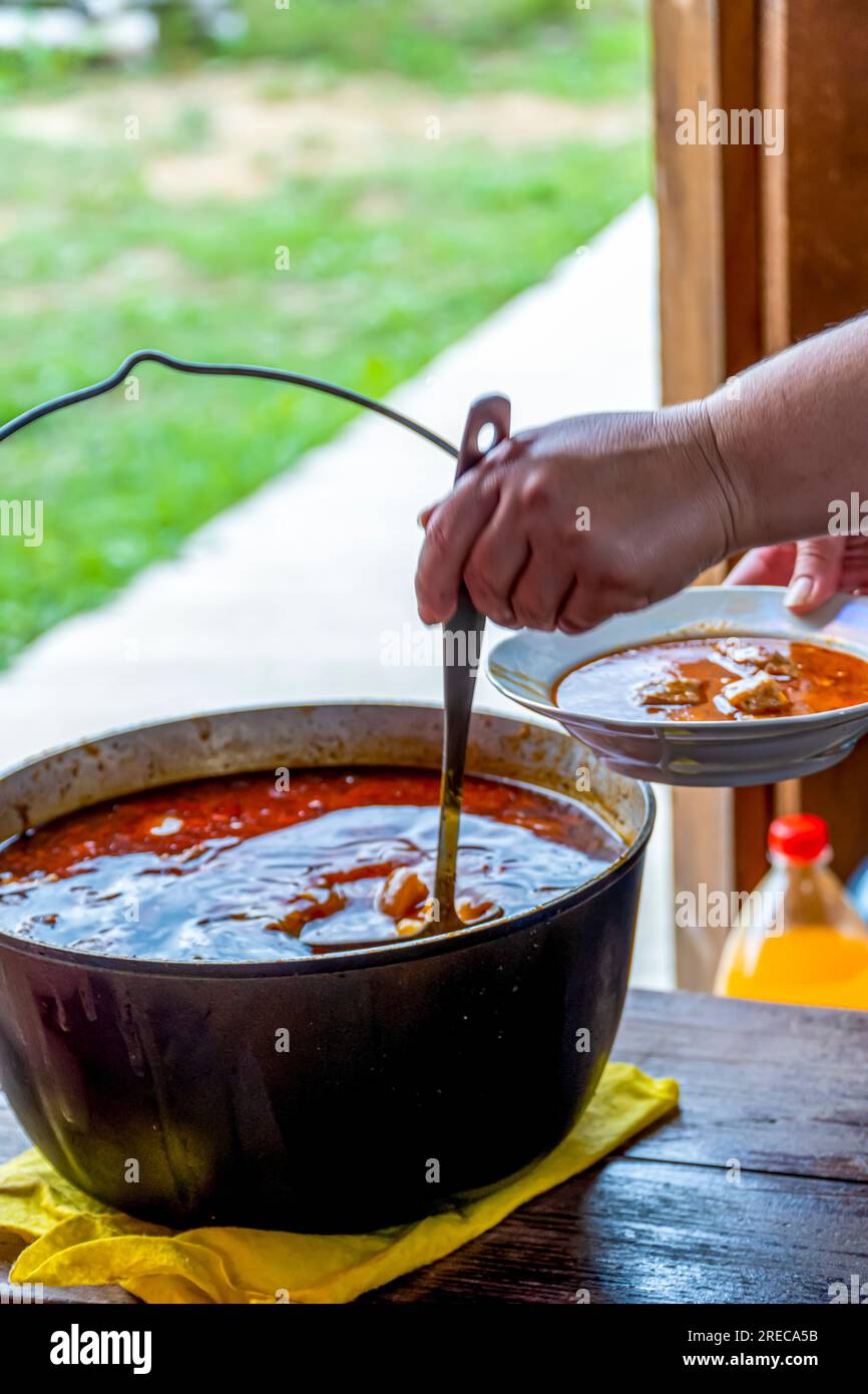 Cooking soup on the street in a cauldron Stock Photo - Alamy