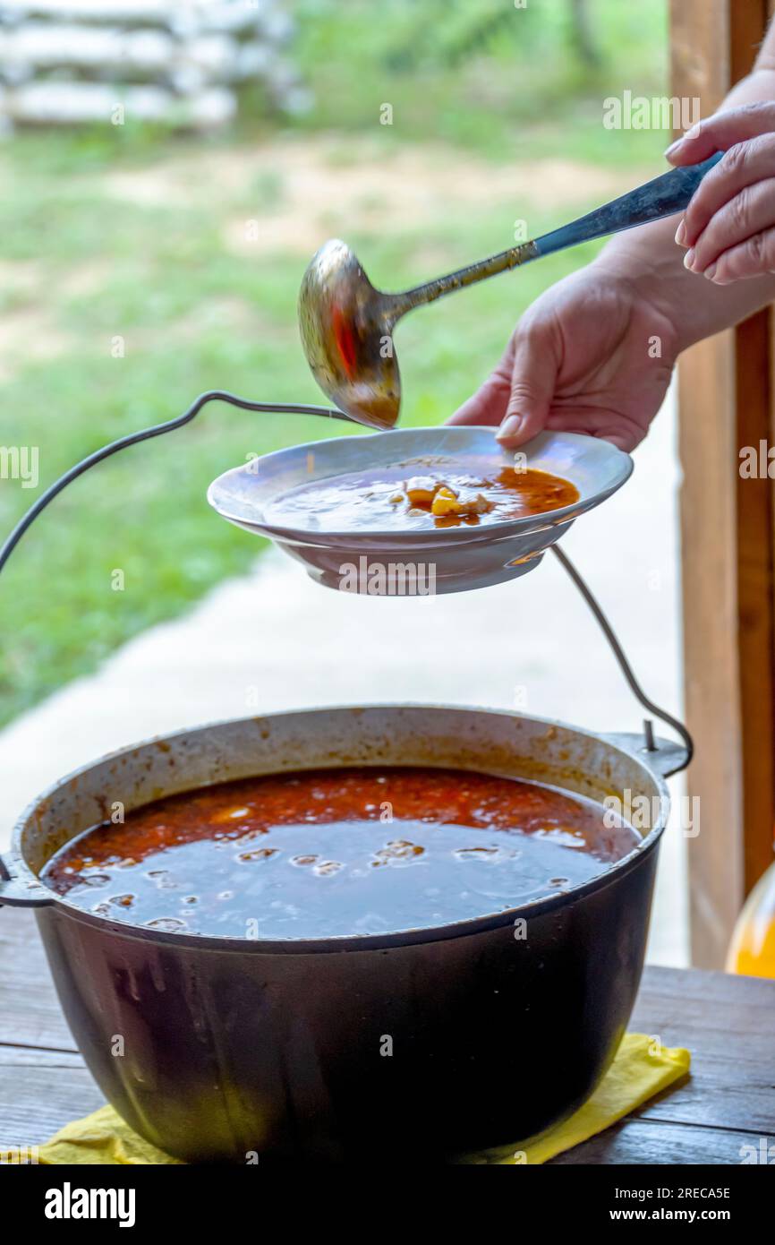 Cooking soup on the street in a cauldron Stock Photo - Alamy