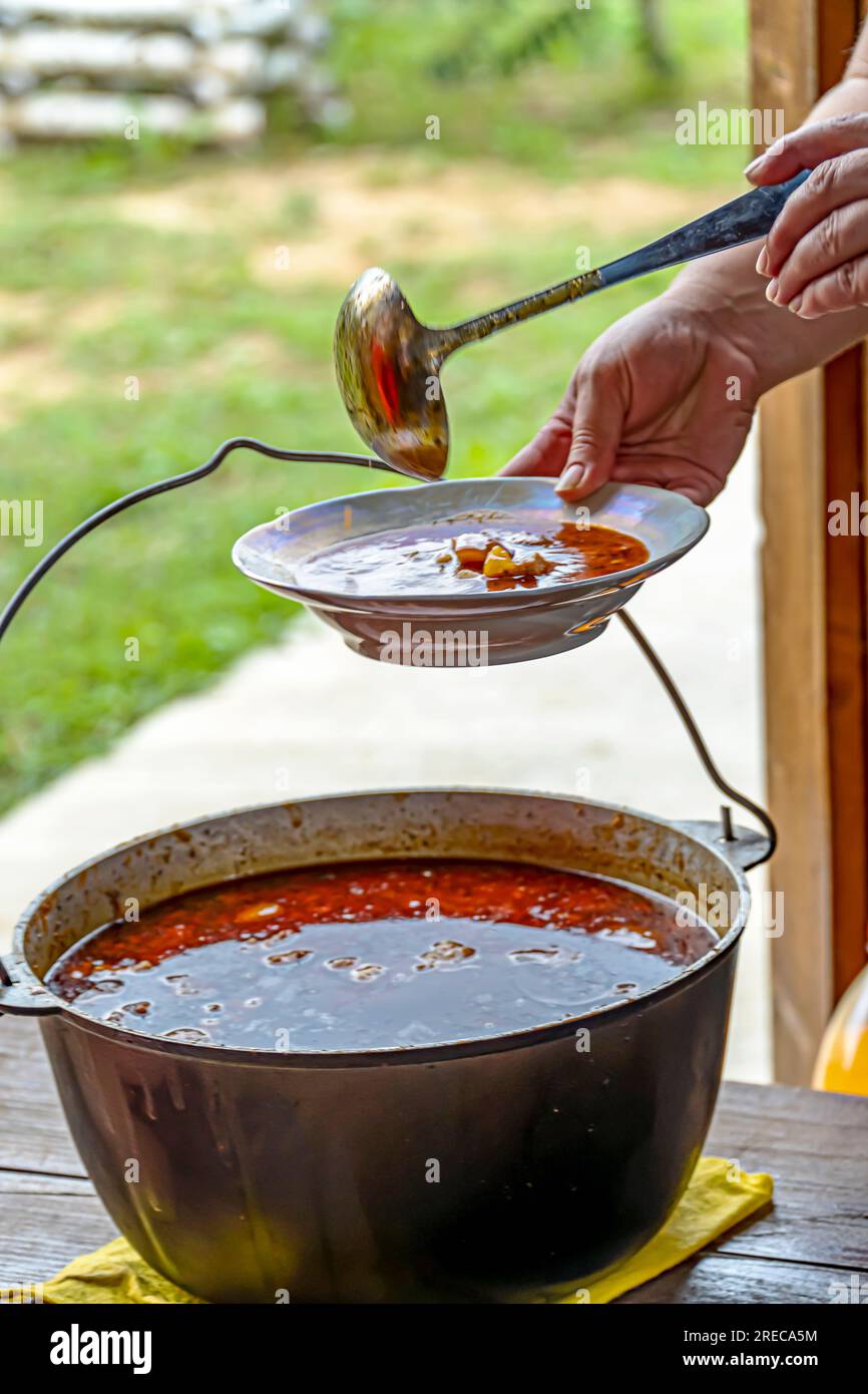 Cooking soup on the street in a cauldron Stock Photo - Alamy