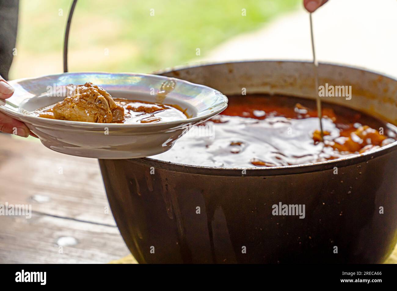 Cooking soup on the street in a cauldron Stock Photo - Alamy
