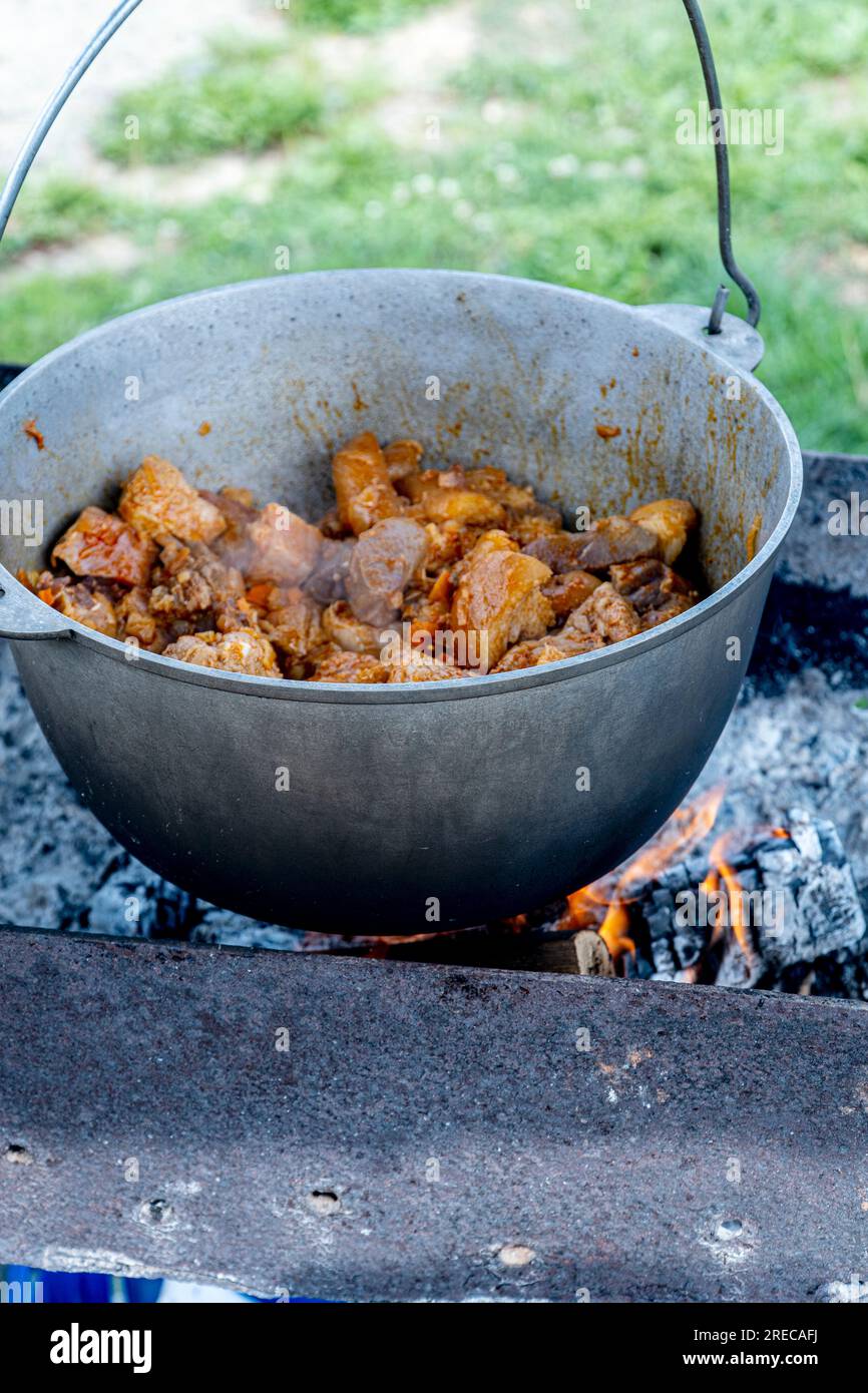Cooking in nature. Kettle on fire Stock Photo - Alamy