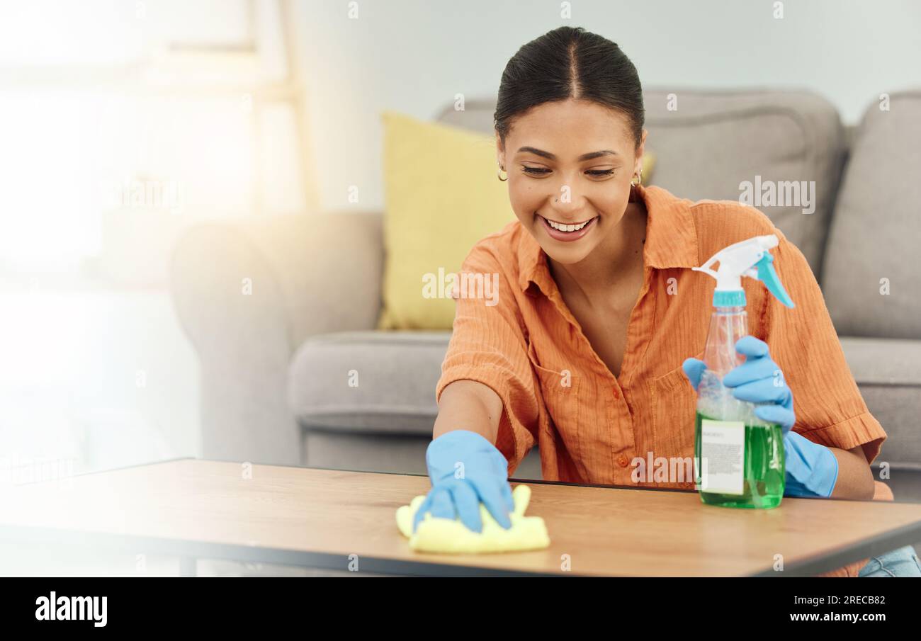 Spray, woman and smile for cleaning table, furniture and housekeeping ...