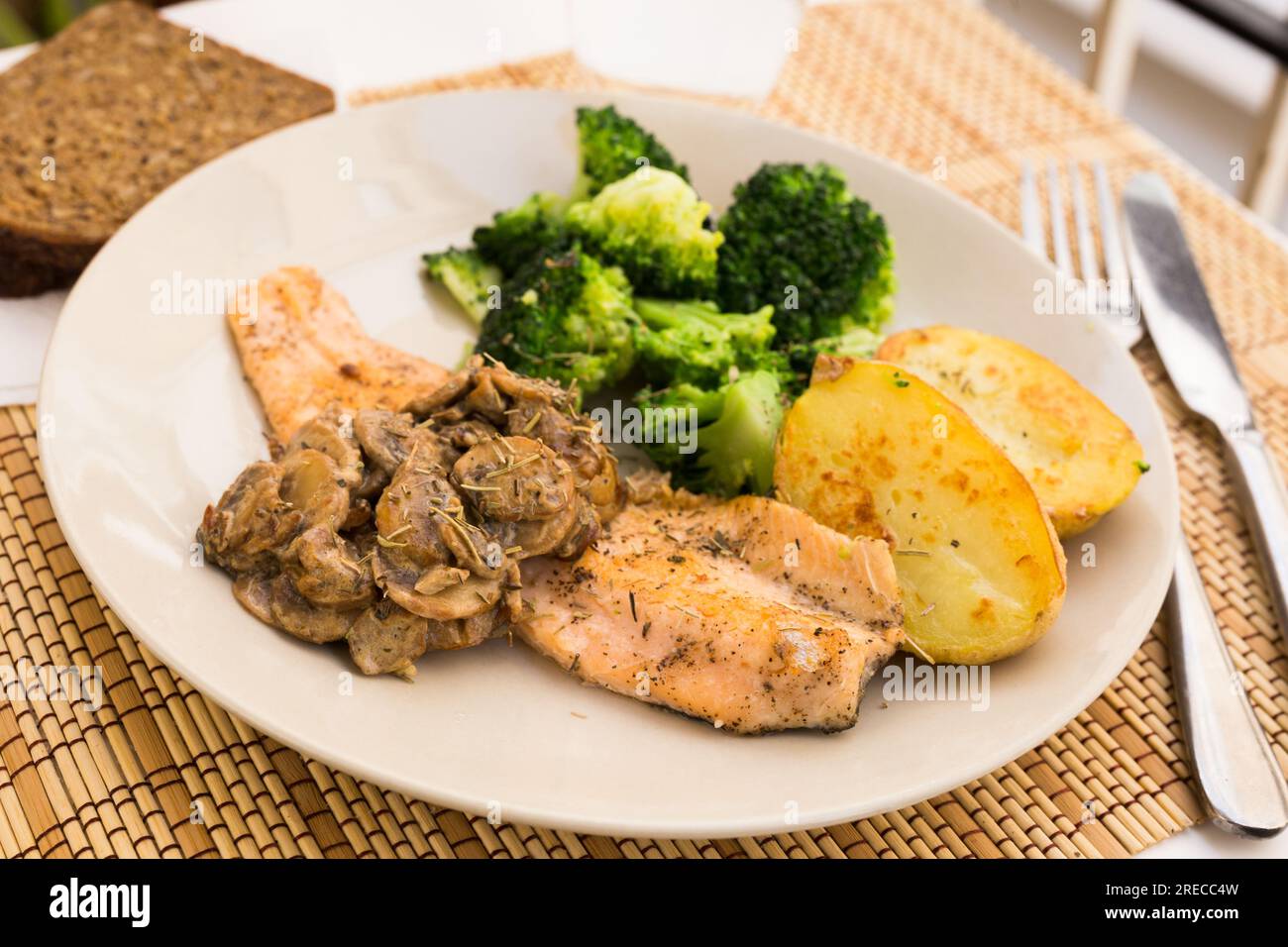 Fried fillet of river trout with a complex side dish Stock Photo - Alamy