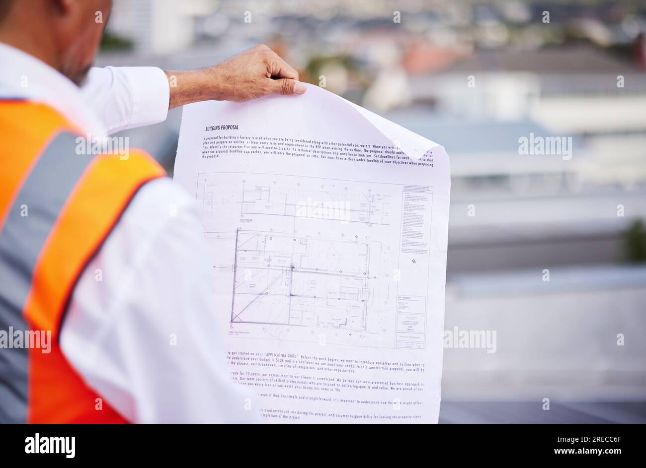 Construction site, blueprint and man reading document of building ...
