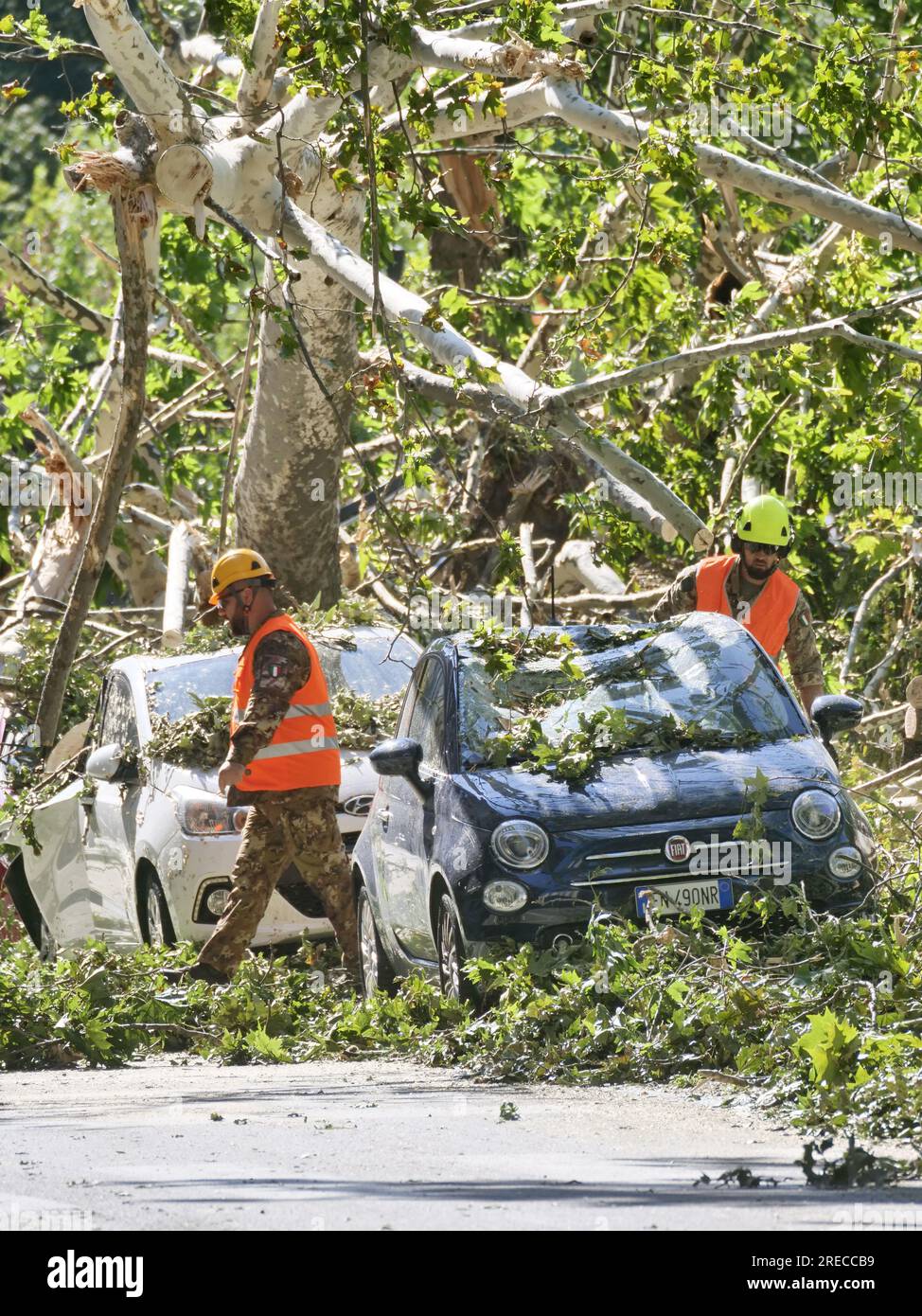 Civil protection operators at work with a chainsaw to free the cars ...