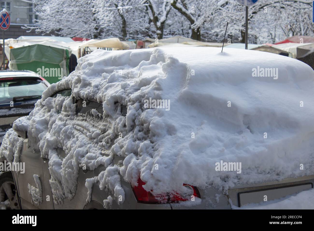 Cars under the snow in the city after heavy snowfall. Winter in the ...
